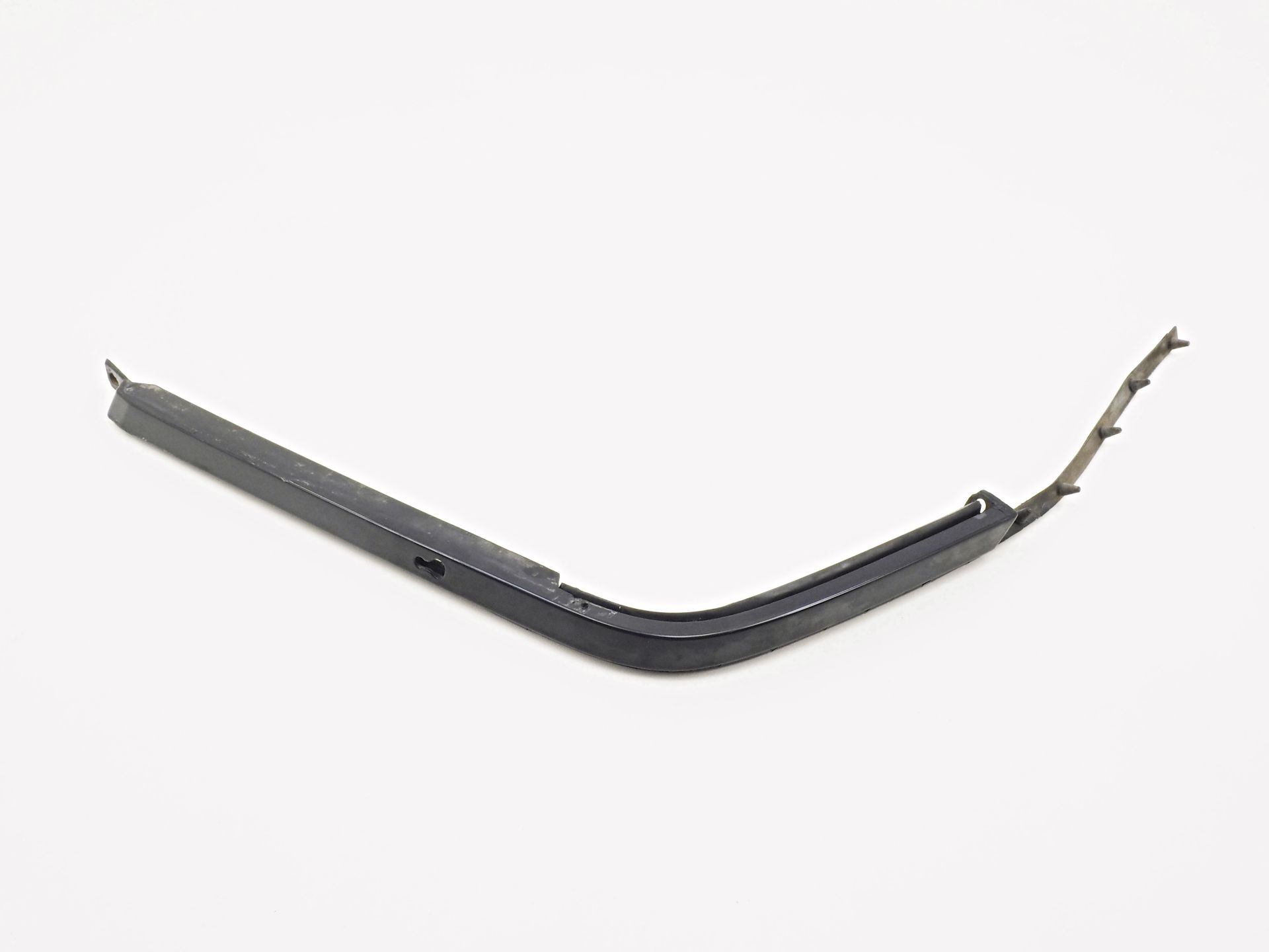 1298260577 - Front left headlight lamp trim | 1981